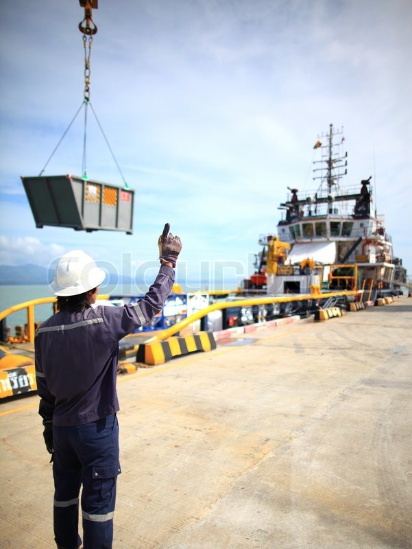Harbor worker - watching the loading ... | Stock image | Colourbox