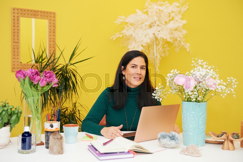 Beautiful middle age woman working in ... | Stock image | Colourbox