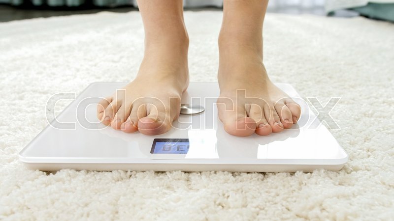 Young Woman Checking Her Weight On Stock Image Colourbox
