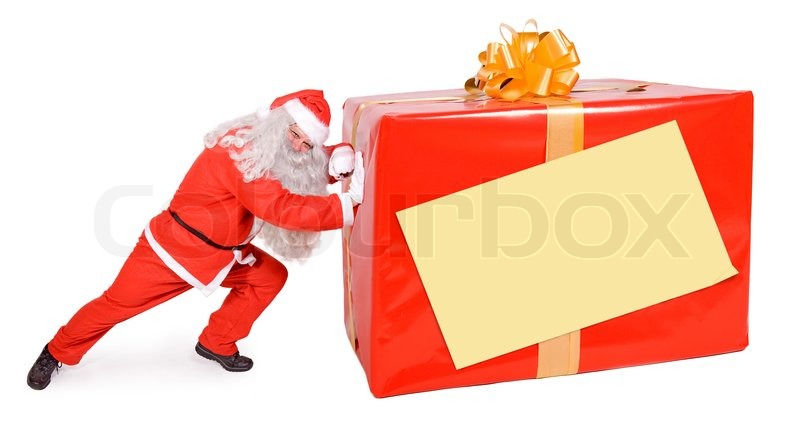 Santa Claus pushing at a big gift | Stock image | Colourbox