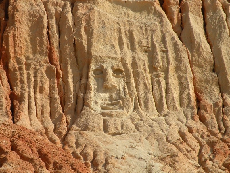 Close up of carved faces in the rock | Stock image | Colourbox