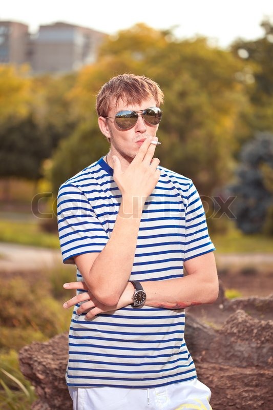 Man smoking a cigarette outside | Stock image | Colourbox
