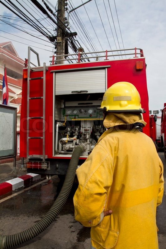Fireman with firetruck | Stock image | Colourbox