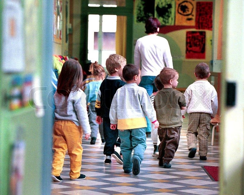 Children walking into school with teacher ahead | Stock Photo | Colourbox