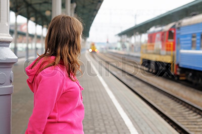 Girl on railway station platform | Stock image | Colourbox