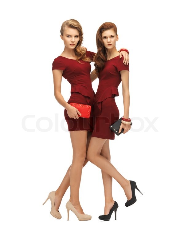 Two teenage girls in red dresses with ... | Stock image | Colourbox