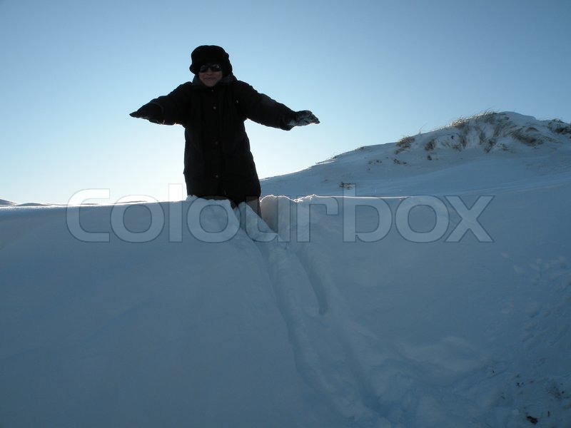 Woman about to fall down into deep snow | Stock image | Colourbox