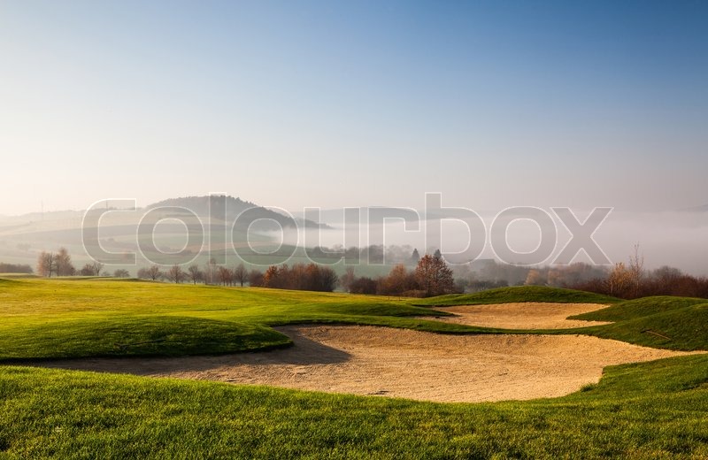 Morning sun on golf course on the hills | Stock image | Colourbox