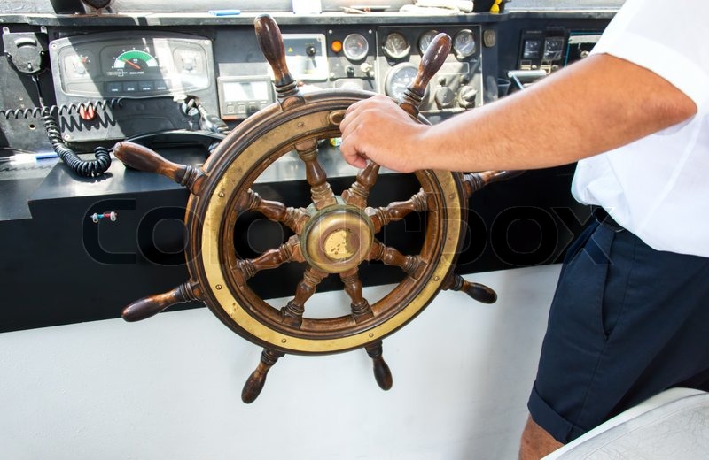 Capitan hand steering a boat | Stock image | Colourbox