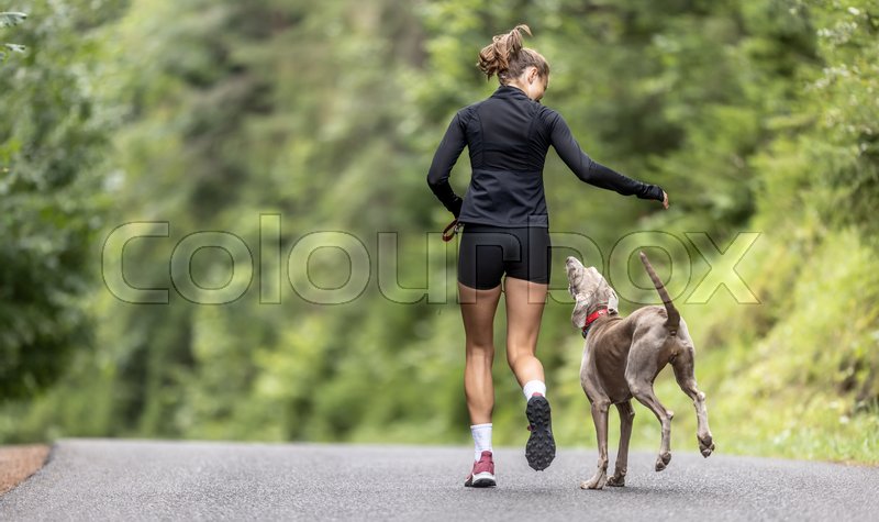 Women Running After Their Dog
