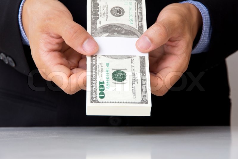 Hand giving money | Stock image | Colourbox