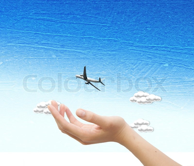Hand with plane over the blue ... | Stock Photo | Colourbox