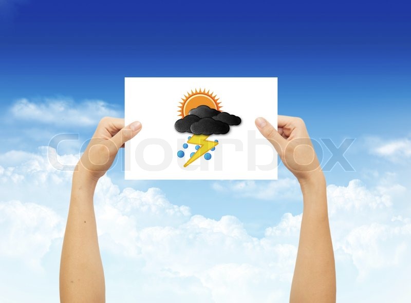 Hand holding a paper with weather sign ... | Stock Photo | Colourbox
