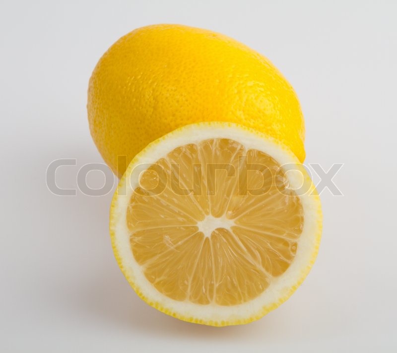 Full and cross section of yellow lemon | Stock image | Colourbox