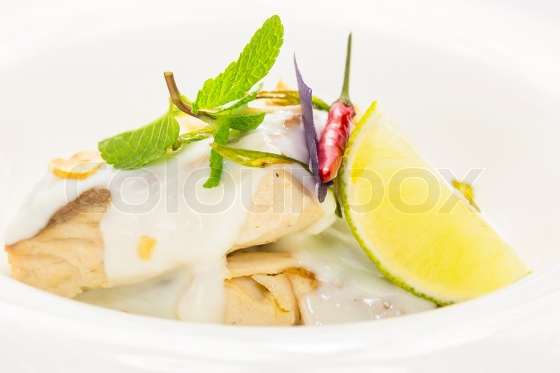 Baked fish in cream sauce with lemon | Stock image | Colourbox
