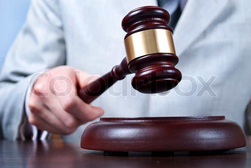 Gavel in the hand | Stock image | Colourbox