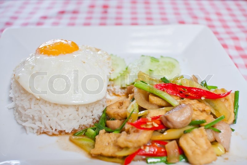 Sunny-side up egg on rice with spicy ... | Stock image | Colourbox