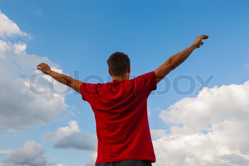 Young man staying with raised hands | Stock image | Colourbox
