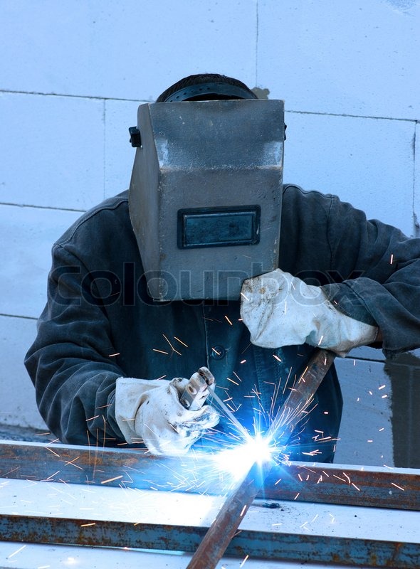 Welder worker welding metal. Bright ... | Stock image | Colourbox