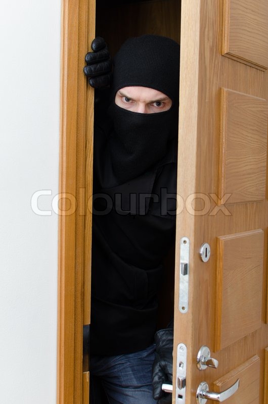 Male burglar in mask breaking into the ... | Stock image | Colourbox
