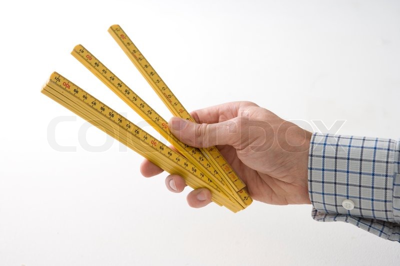 A man holding a wooden ruler | Stock image | Colourbox