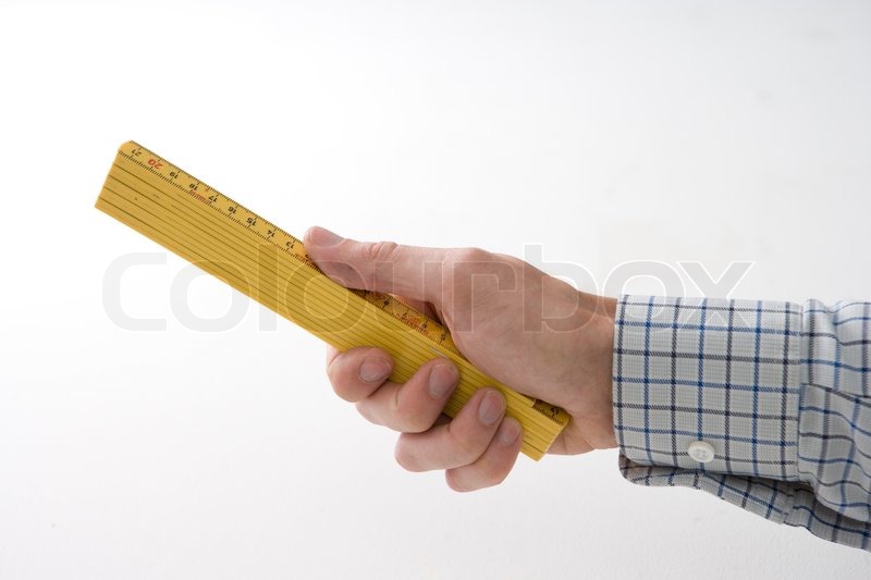A man holding a wooden ruler | Stock image | Colourbox