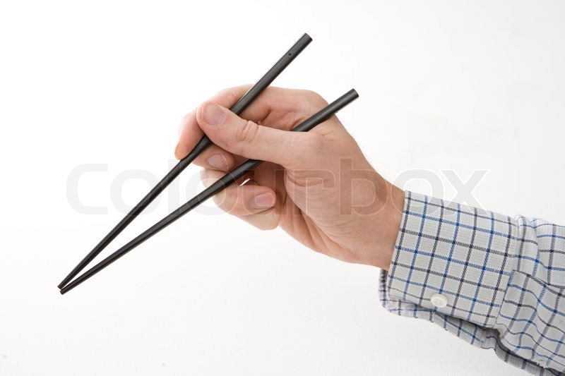 A man holding chopsticks | Stock image | Colourbox