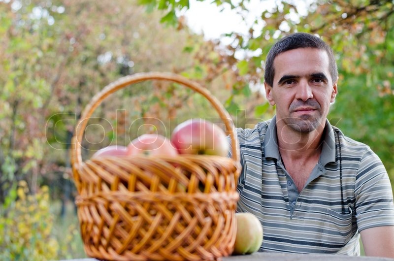 Portrait of smiling man with a fruit ... | Stock image | Colourbox