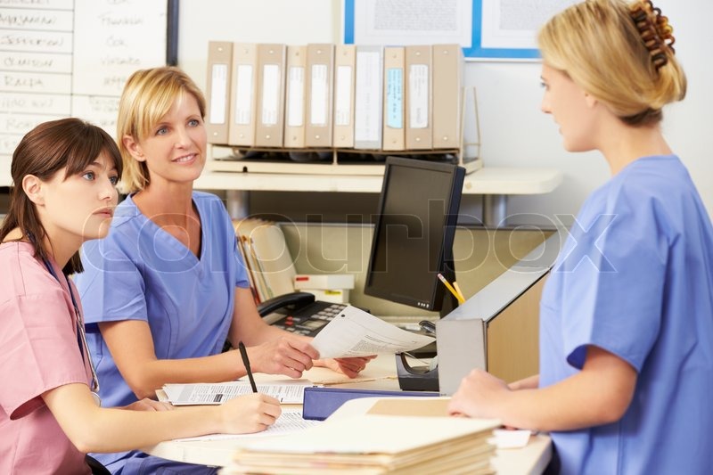 Three Nurses Working At Nurses Station | Stock image | Colourbox
