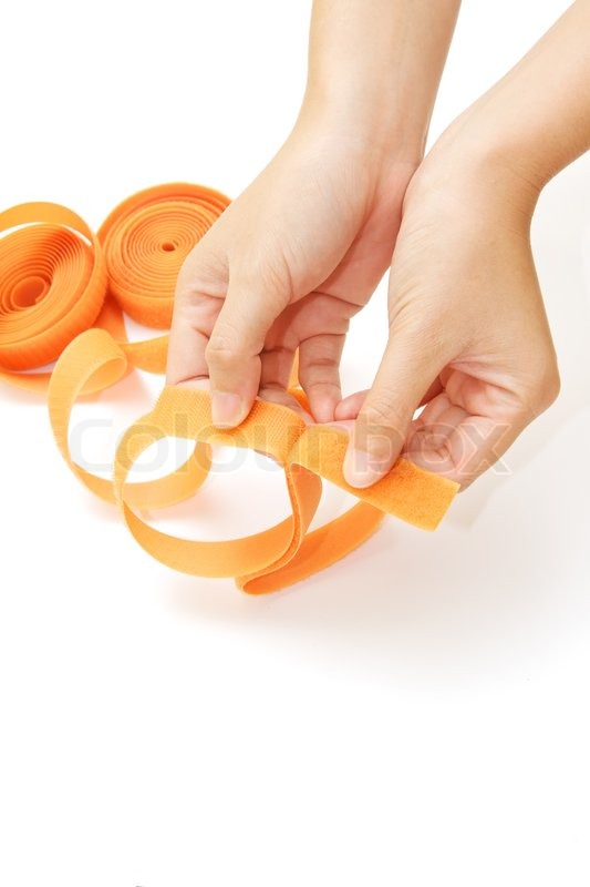 Hand holding roll of velcro on white ... | Stock image | Colourbox