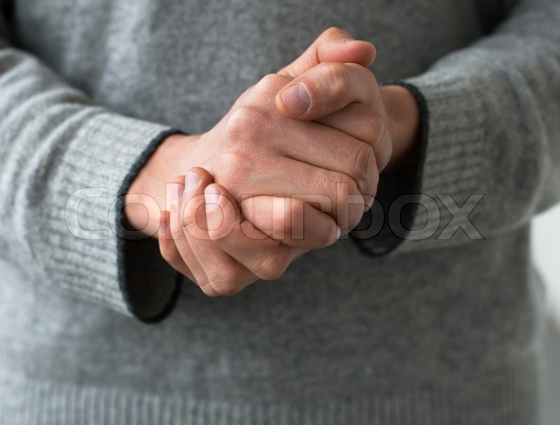 A man holds his hands folded | Stock image | Colourbox