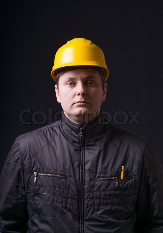 Man with helmet in hand on a black ... | Stock image | Colourbox