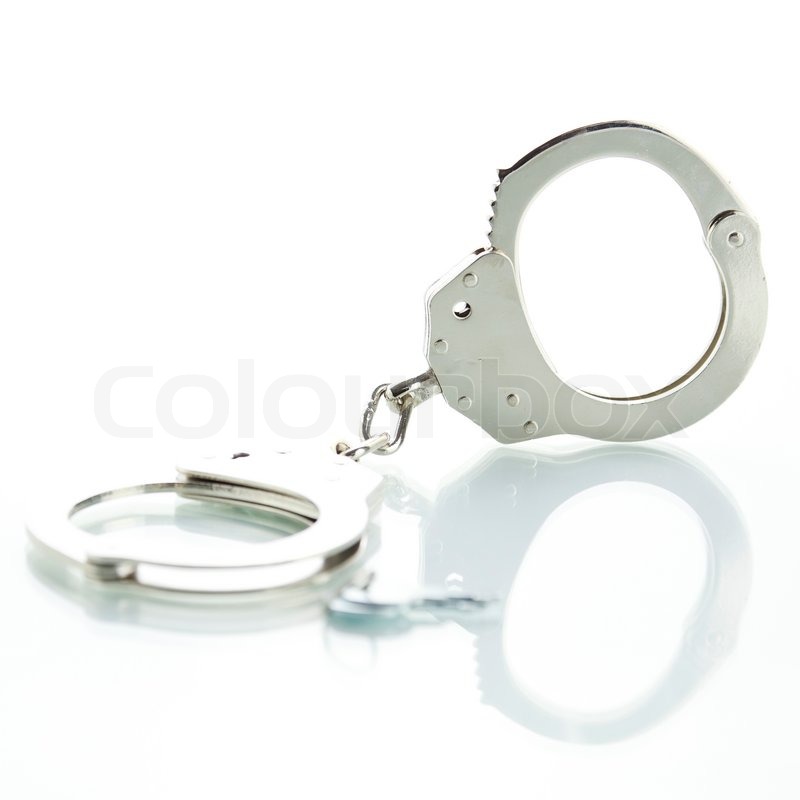Handcuffs with shadow on a white ... | Stock image | Colourbox