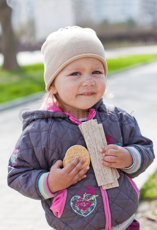 Crying child eating cookies in the ... | Stock image | Colourbox