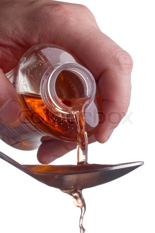 Liquid medicine poured into a spoon. ... | Stock image | Colourbox