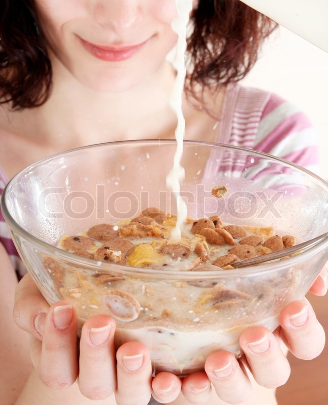 Young people eating milk with cereals | Stock image | Colourbox