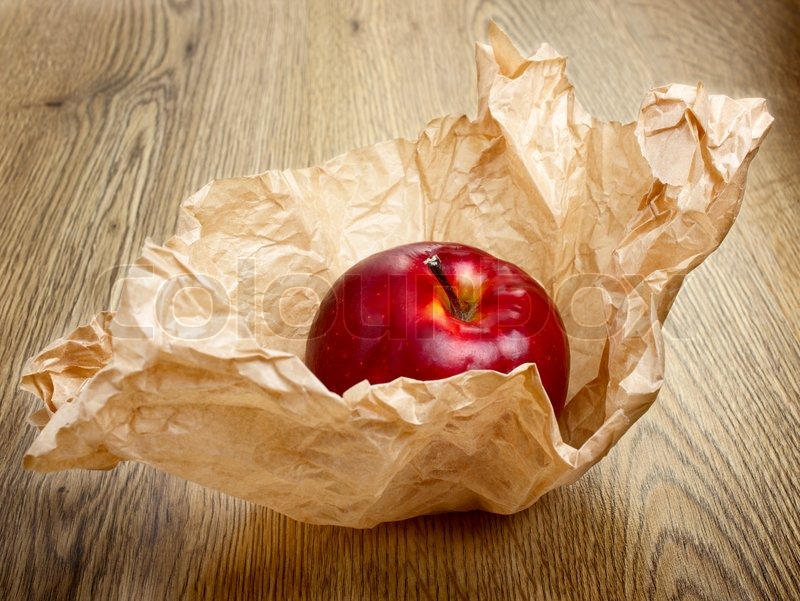 Red apple on wrapping paper | Stock image | Colourbox