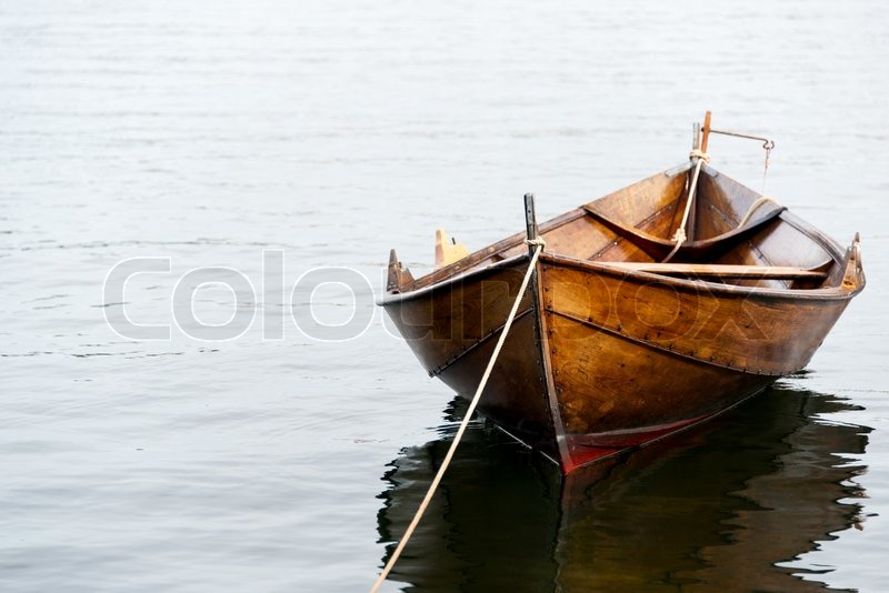 Old wooden row boat on water | Stock image | Colourbox