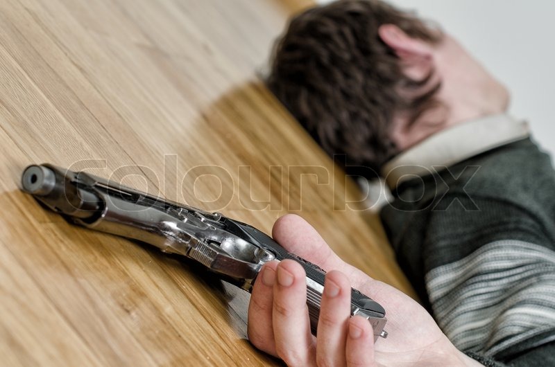 Man with gun laying on the floor | Stock image | Colourbox