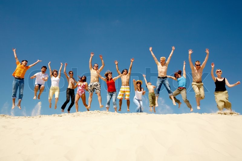 Crowd of friends jumping on sandy beach ... | Stock image | Colourbox
