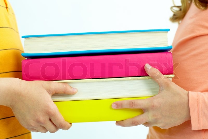 Close-up of childish hand giving books ... | Stock image | Colourbox