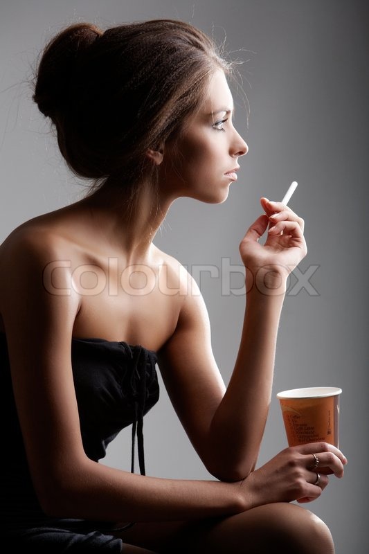 Portrait of elegant female smoking with ... | Stock image | Colourbox