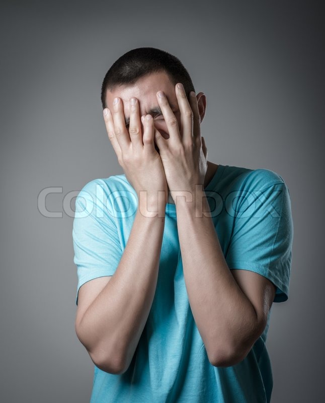 Man covered his face with his hands on ... | Stock image | Colourbox