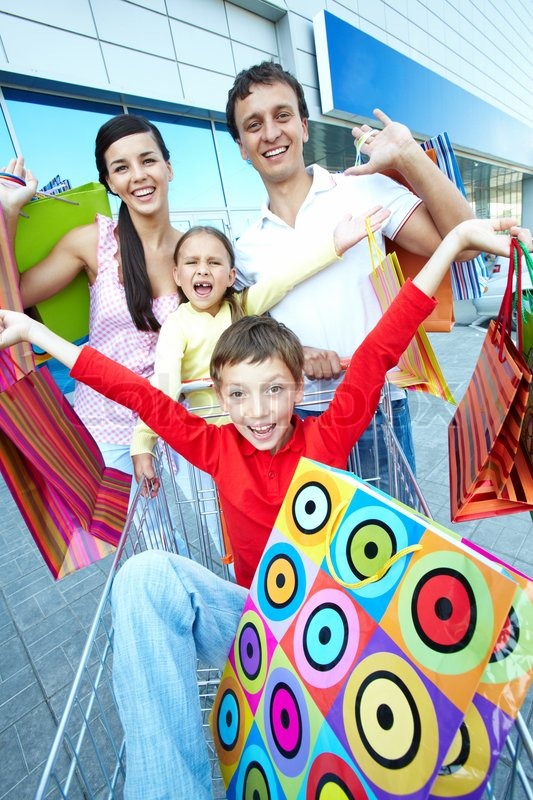 Portrait of happy shoppers with paper ... | Stock image | Colourbox