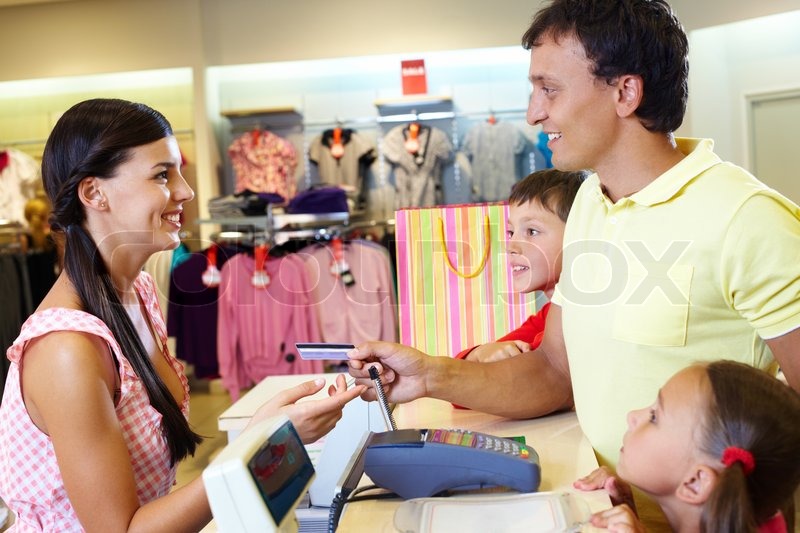 Man with two children paying for ... | Stock image | Colourbox