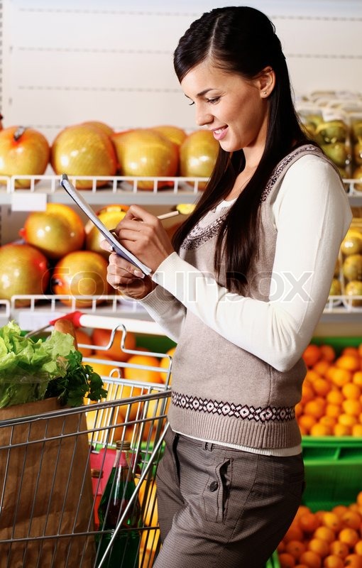 Image of pretty woman ticking what she ... | Stock image | Colourbox