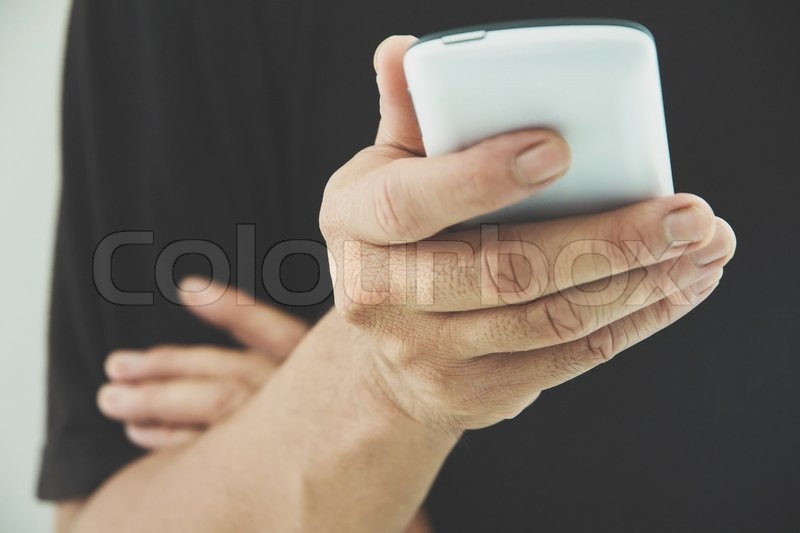 Man checking his phone | Stock image | Colourbox