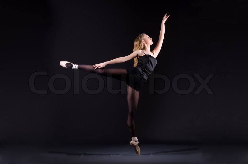 Ballerina dancing in the dark studio | Stock image | Colourbox