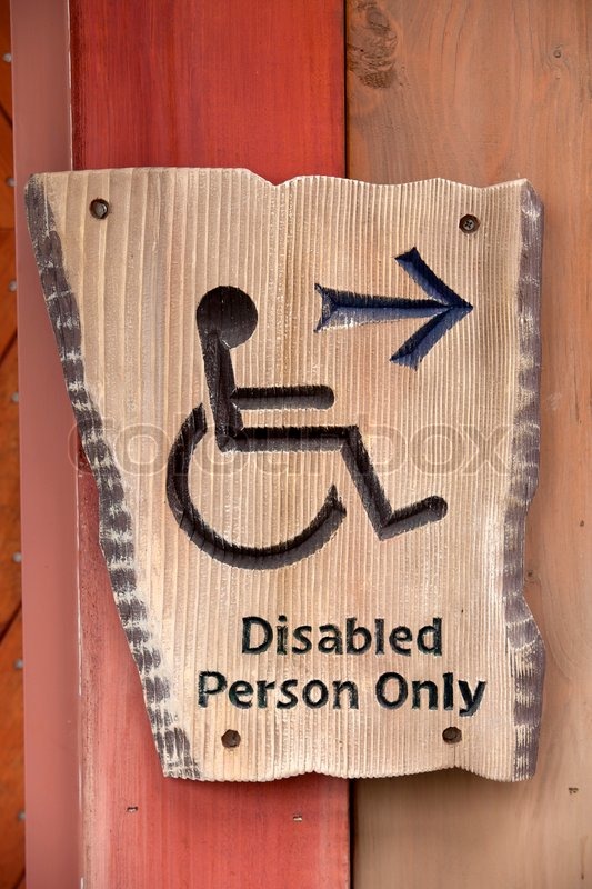 A handicapped sign on wood wall | Stock image | Colourbox