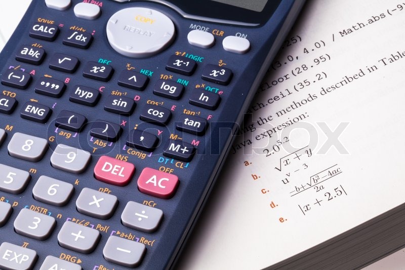 Calculator place on text book | Stock image | Colourbox